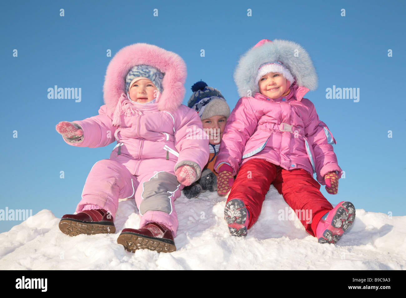 Three children in snow Stock Photo - Alamy