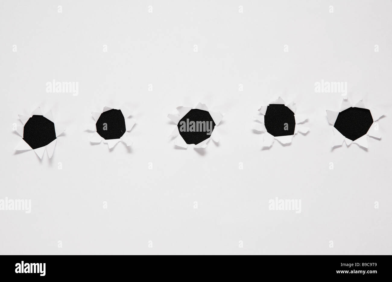 sheet of paper with row of holes Stock Photo - Alamy