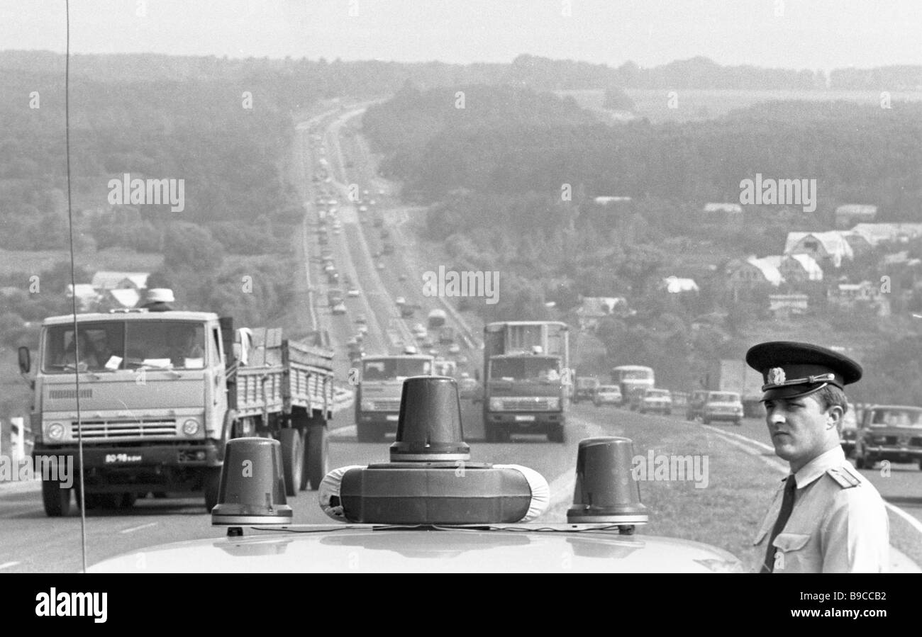A traffic police inspector monitoring traffic on a motor road Ukraine ...