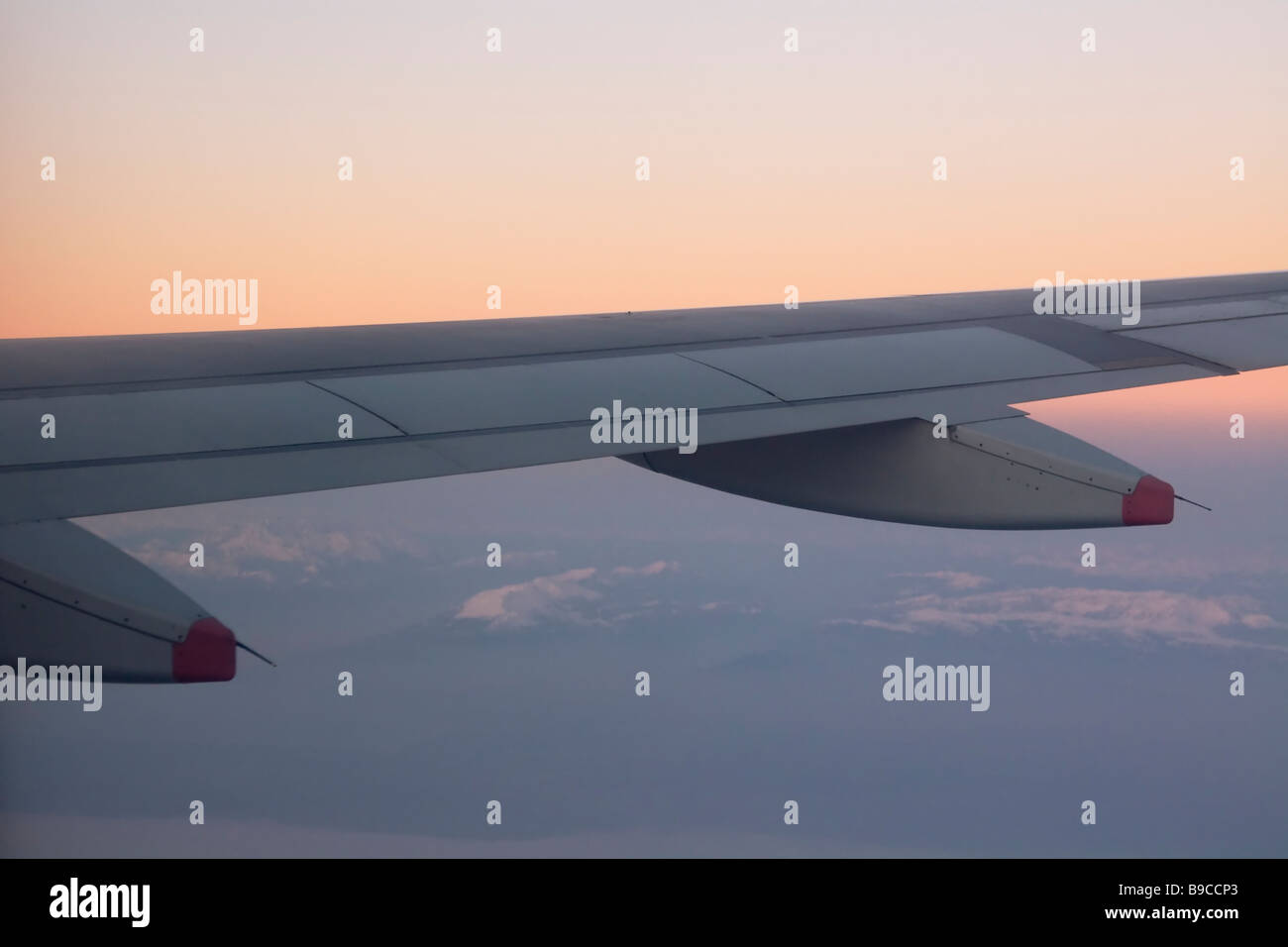 View over aircraft wing at sunset Stock Photo - Alamy