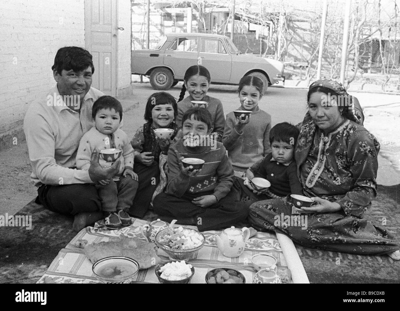 Turkmen family drinking tea on the porch of their house Stock Photo - Alamy