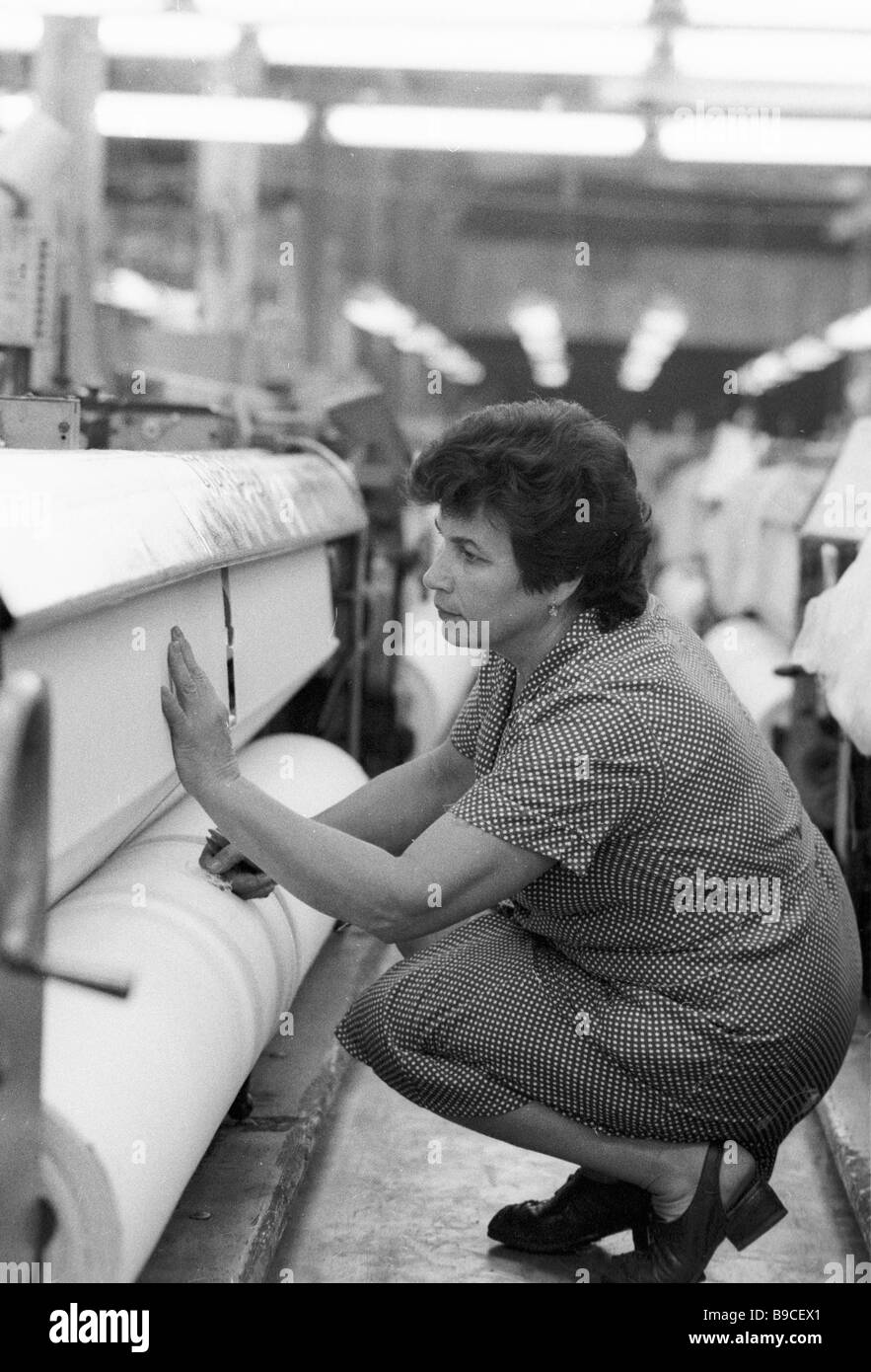 The Shcherbatov silk integrated mill s weaver checking the alignment of ...