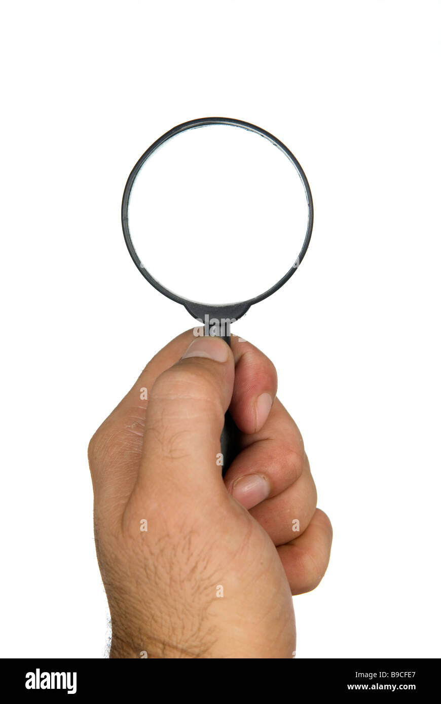 Man's hand holding a magnifying glass cutout against a white background ...