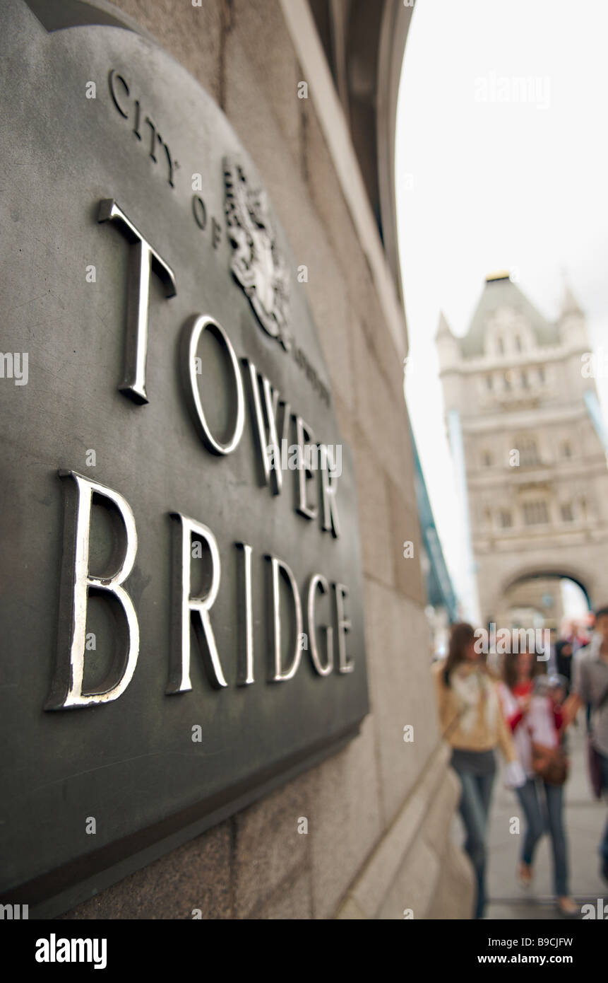 Angled shot of Tower Bridge sign with the Tower in the background with ...