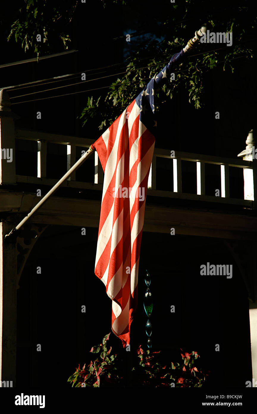 American flag hangs from porch hi-res stock photography and images - Alamy