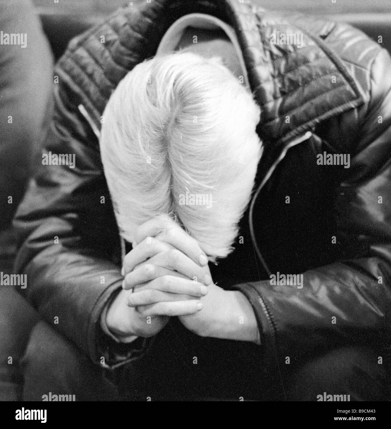 Man sitting with lowered head Stock Photo - Alamy