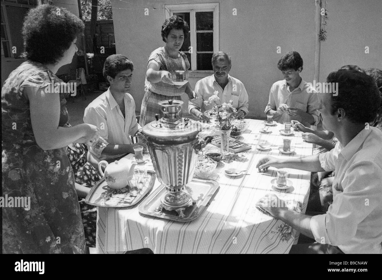 Oil industry workers family drinking tea from the samovar Stock Photo ...