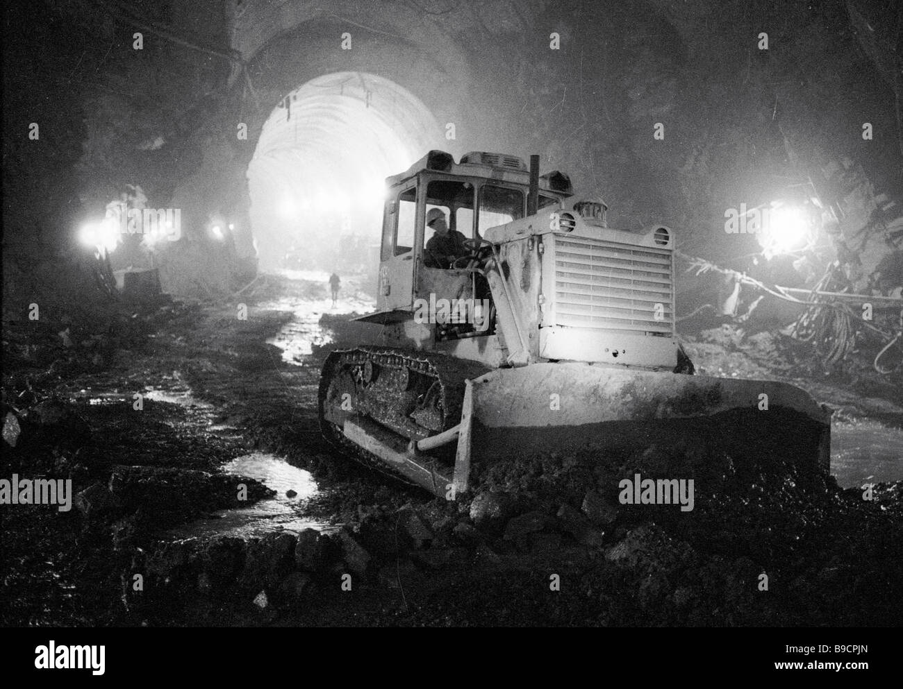 A bulldozer at the construction of a traffic tunnel to the dam of the ...