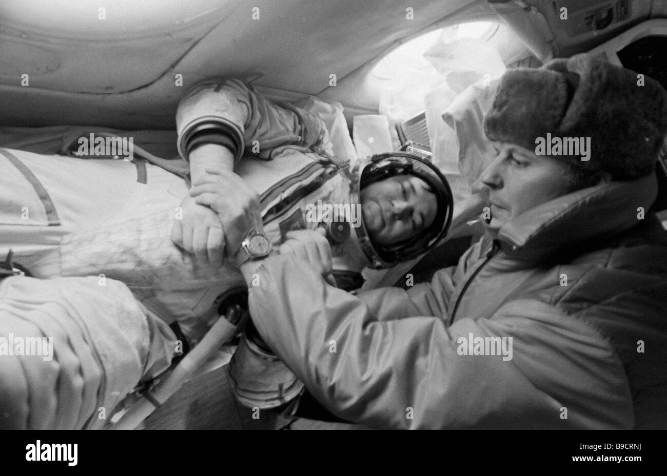 Doctor checking the pulse of cosmonaut Yury Romanenko spacecraft ...