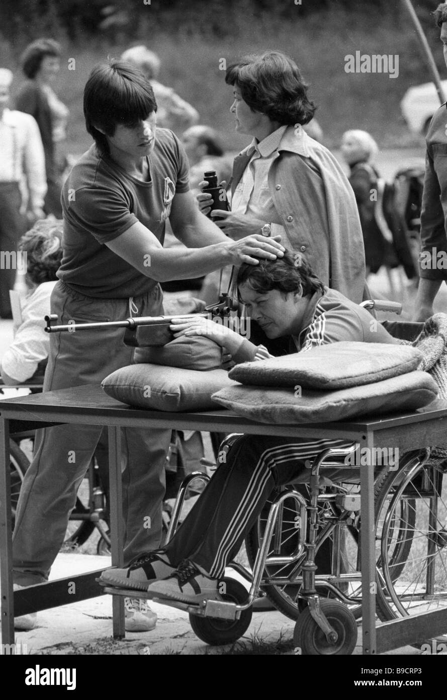 A physical therapy coach Sergei Djumayev left helps a female ...