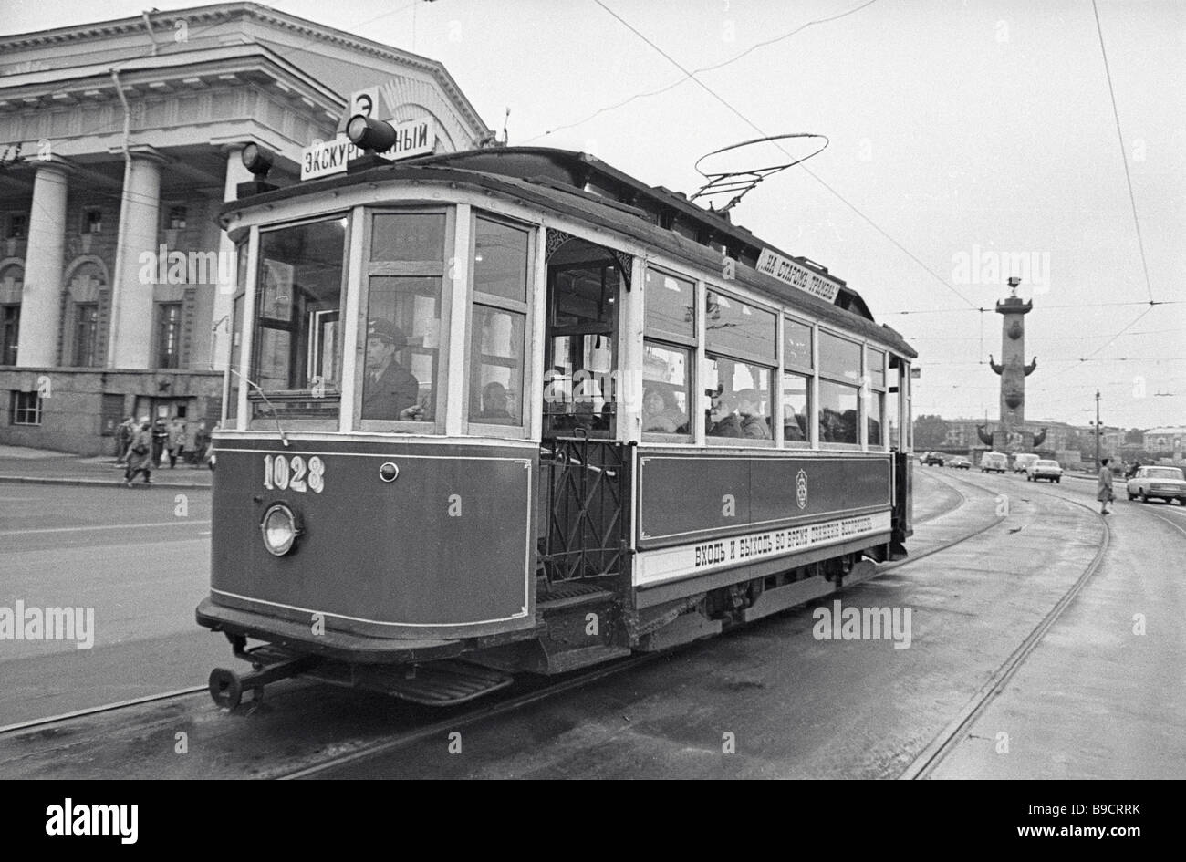 Old tram moves along city street Stock Photo - Alamy