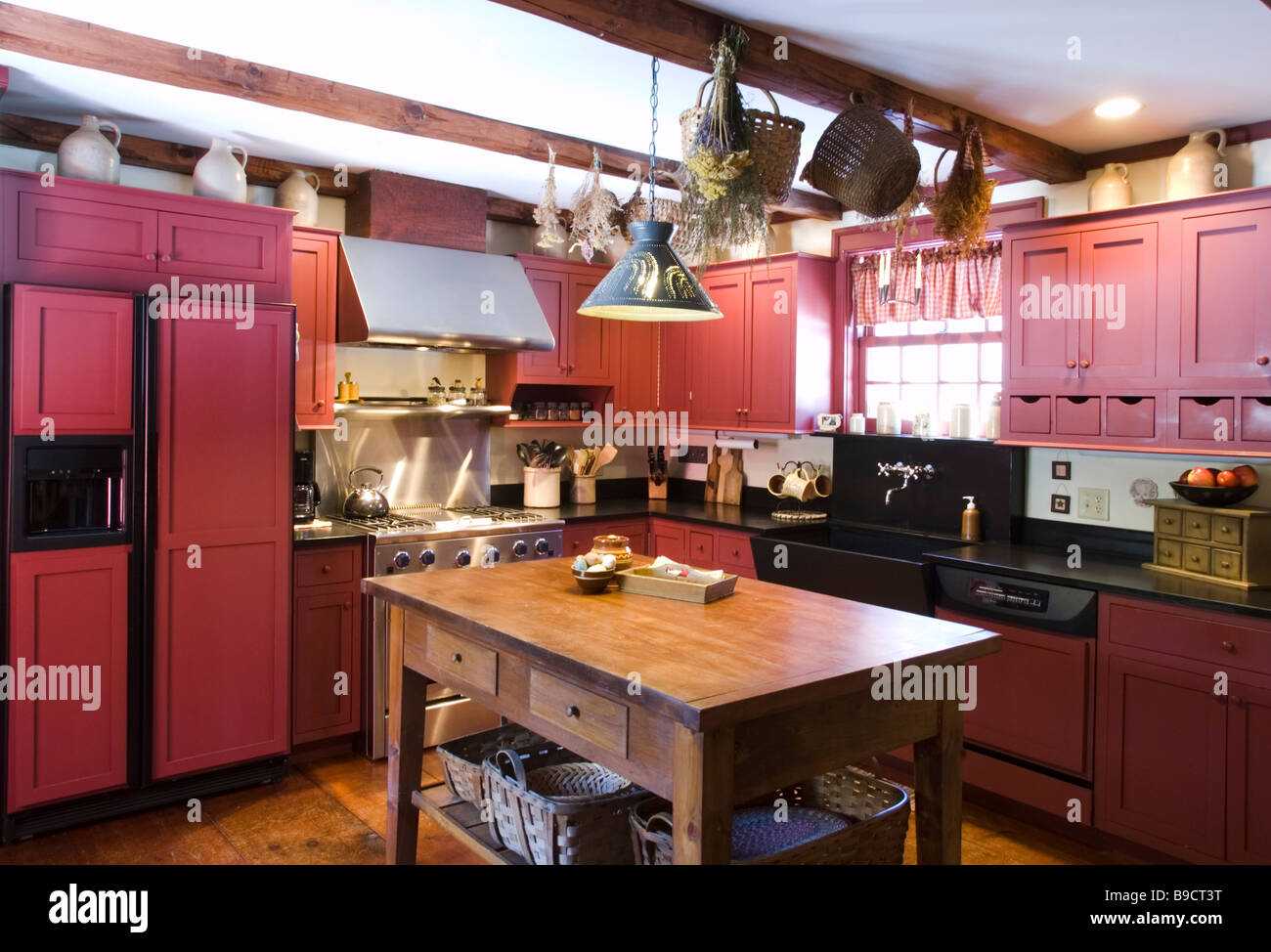 Kitchen in colonial house with red cabinets Stock Photo - Alamy