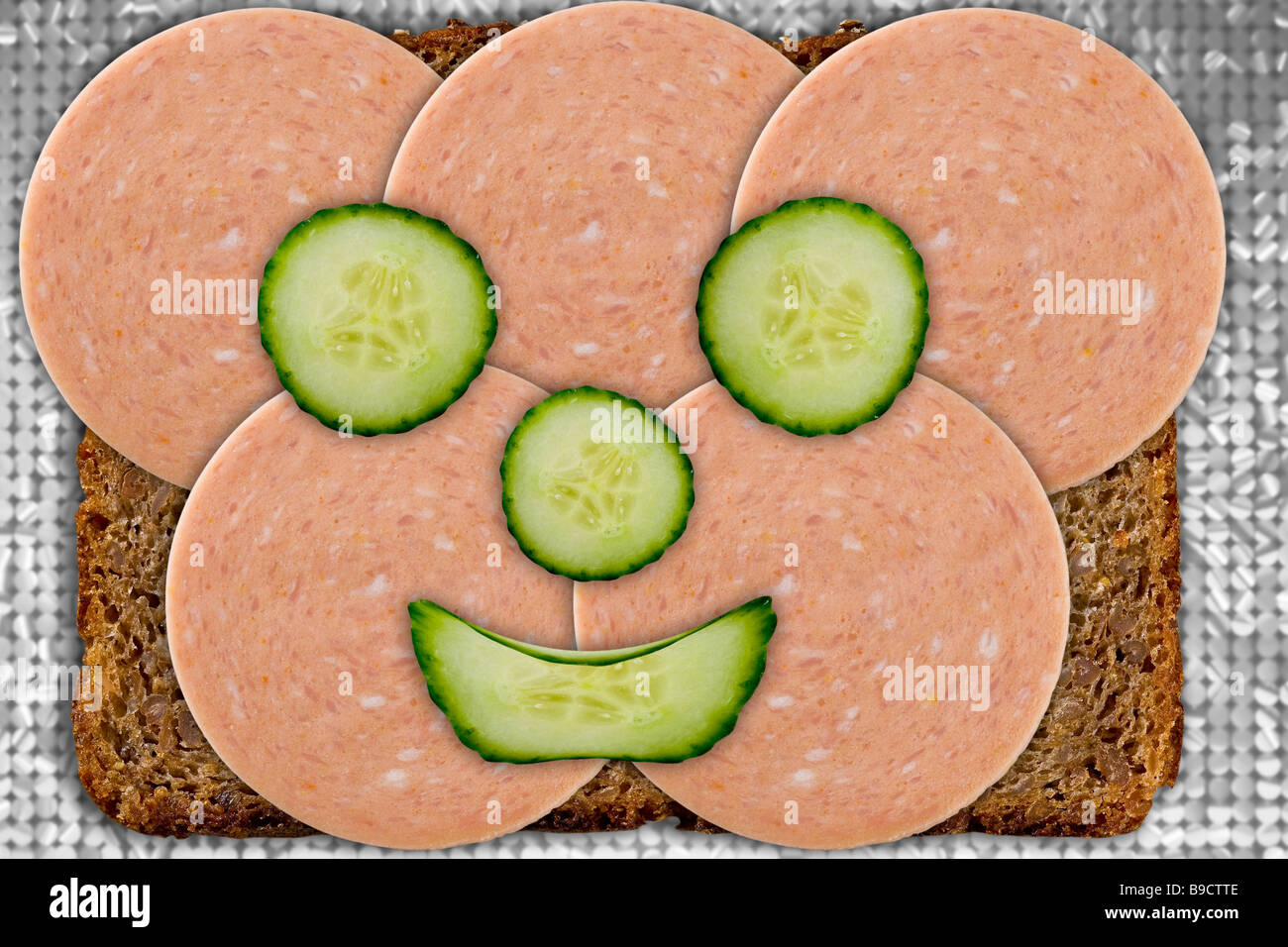 Slice of rye bread with face shaped food Stock Photo - Alamy