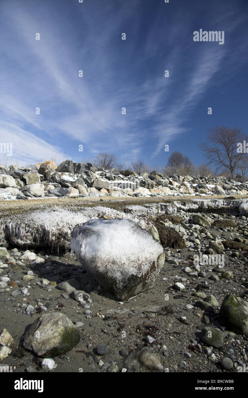 Frozen shoreline with iced rocks and blue sky Stock Photo - Alamy