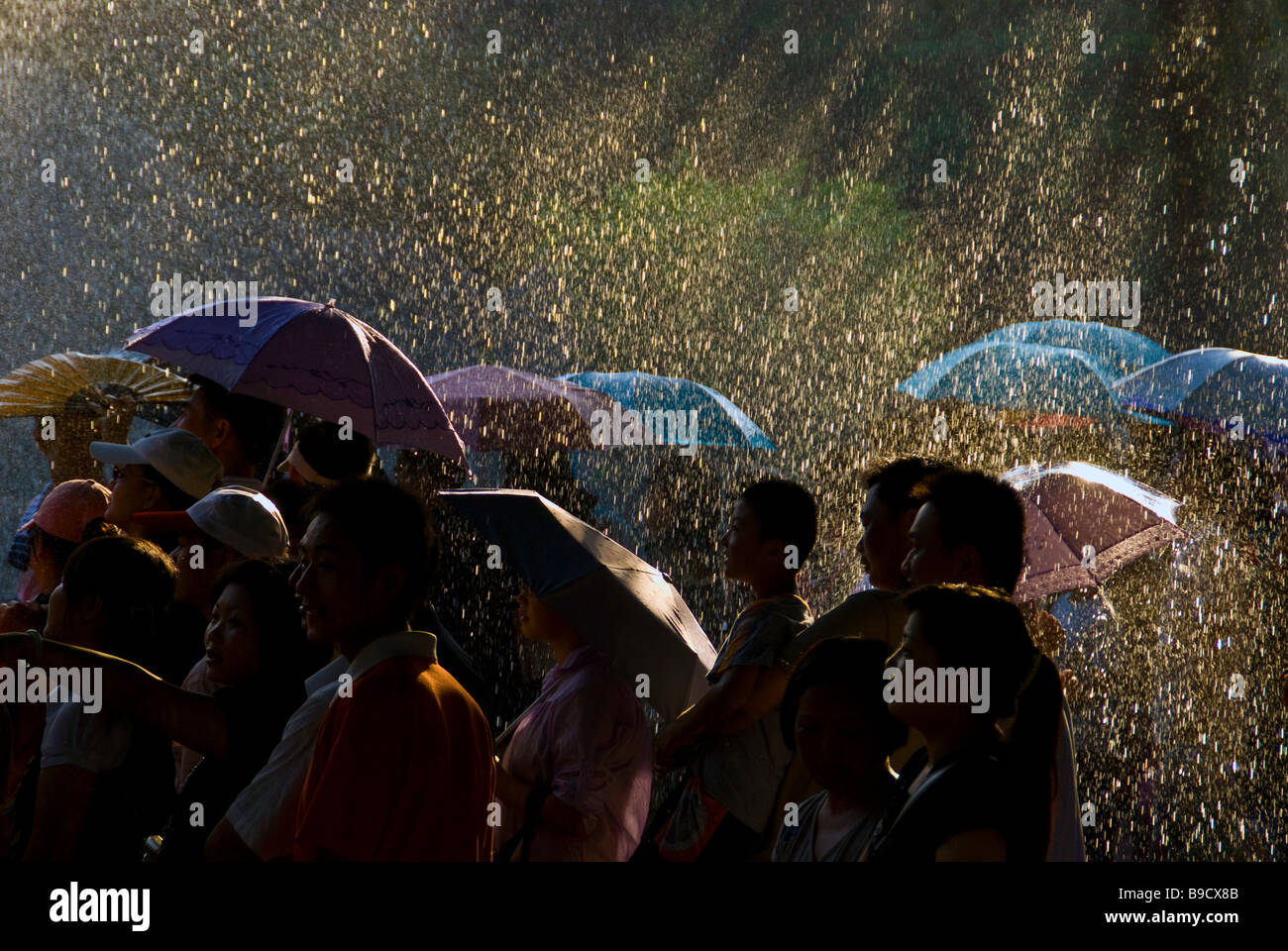 A sprinkling of rain sprays down on a crowd watching a performance in ...