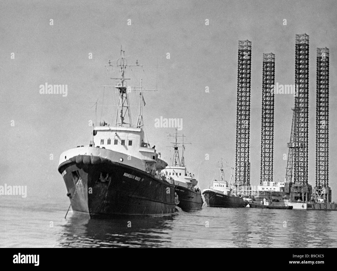 Powerful tugboats pulling a floating oil rig to a new site Stock Photo ...