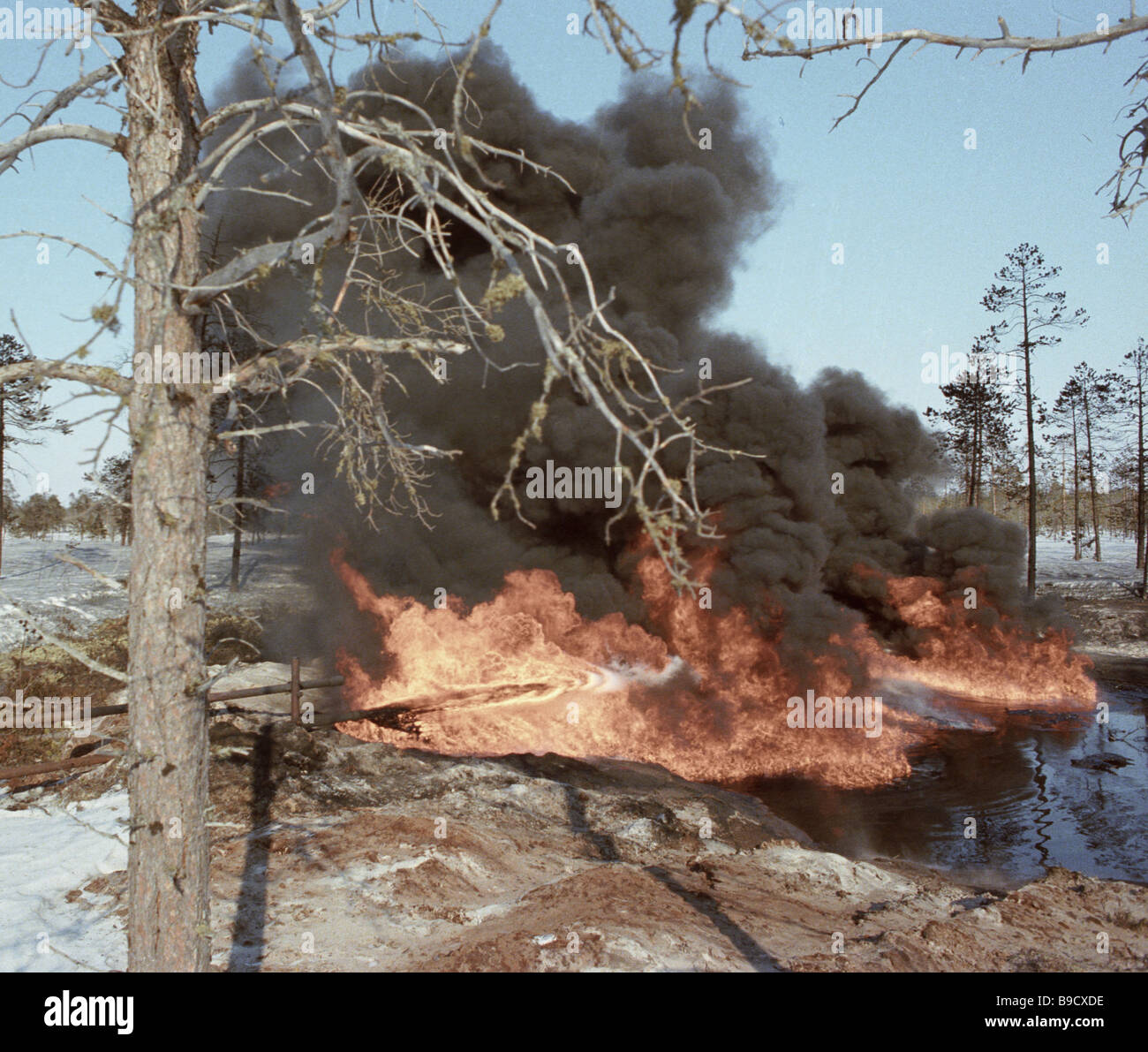 Burning pools of oil released from pipes for checking Stock Photo - Alamy