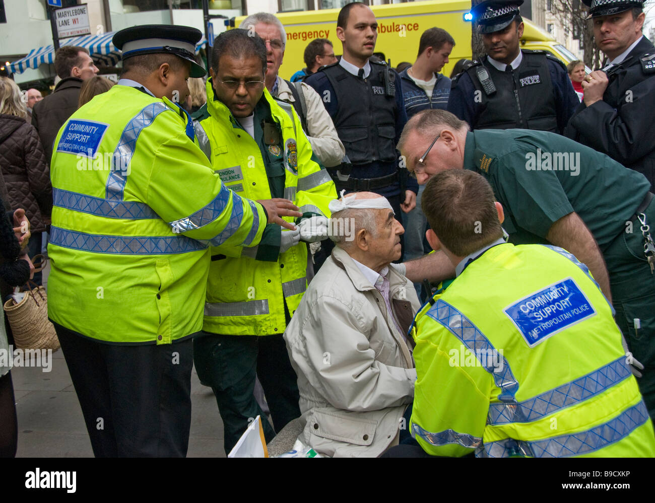 community police and ambulance crew help older man injured in street ...