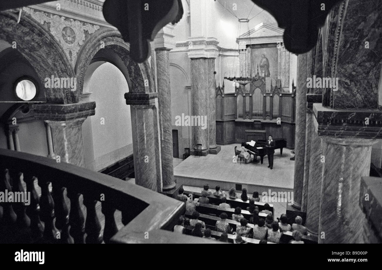 A singer performing in a concert hall in an old church Stock Photo - Alamy