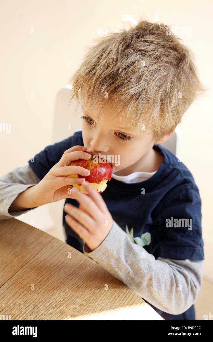 Young Boy Eating an Apple Stock Photo - Alamy