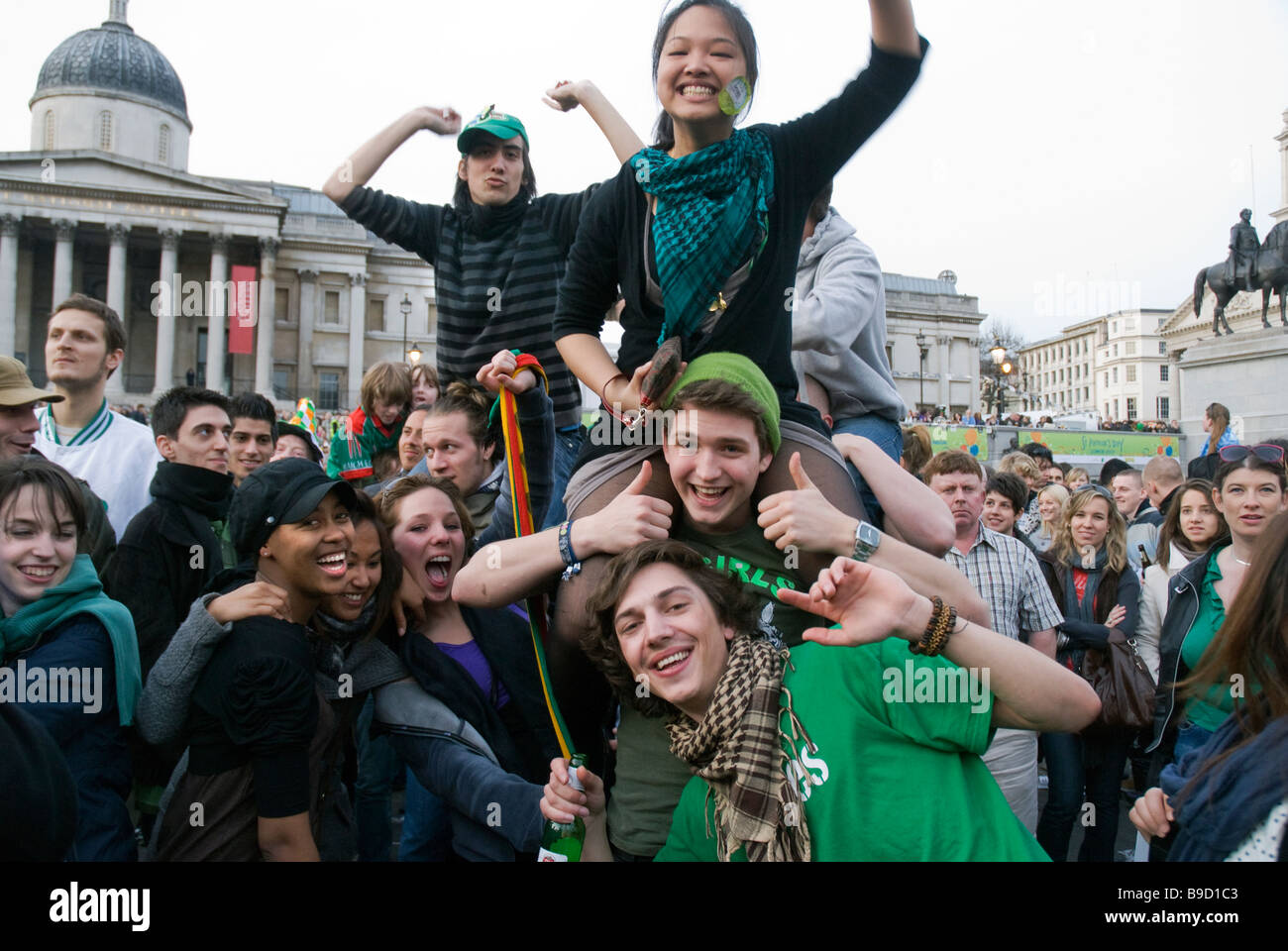 Group of multicultural young men and women celebrating together at St ...
