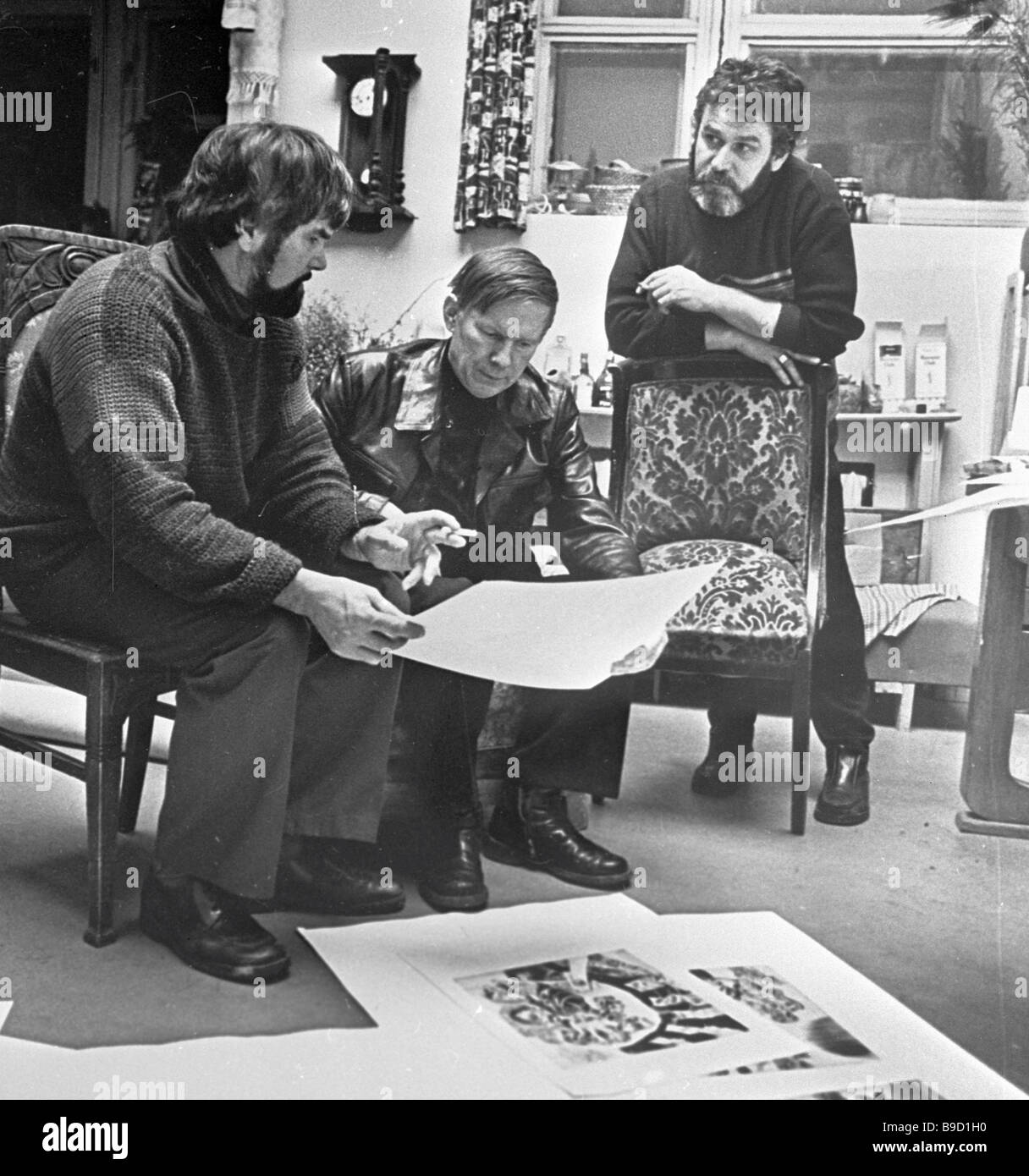 Artist Georgy Poplavsky left showing his new works to writer Vasil ...