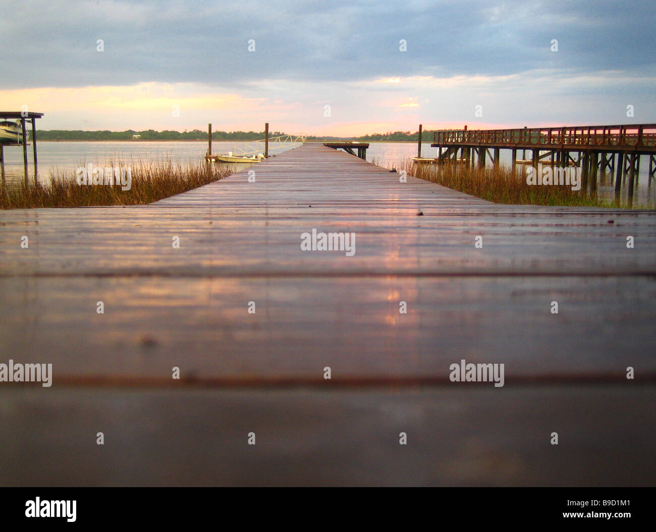 Dock leading to river Stock Photo - Alamy
