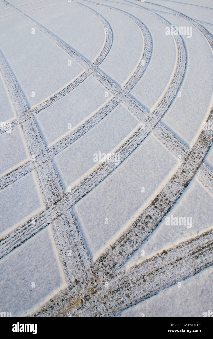 Geometric patterns arise from the tire tracks in fresh snow in a ...