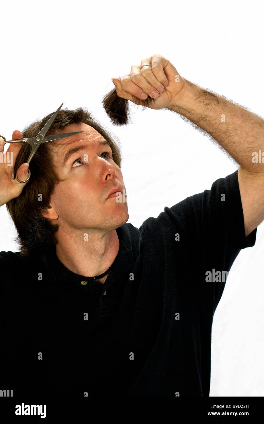 A man cutting his hair Stock Photo - Alamy