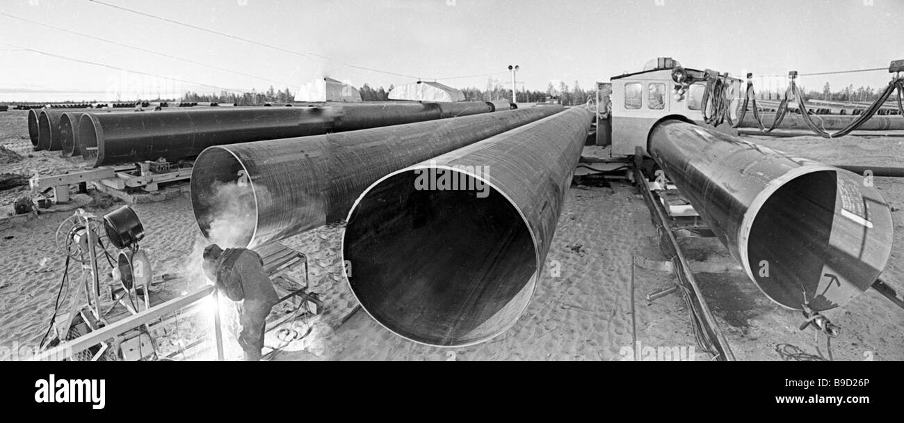 An operator performing electro arc welding of large diameter pipes ...
