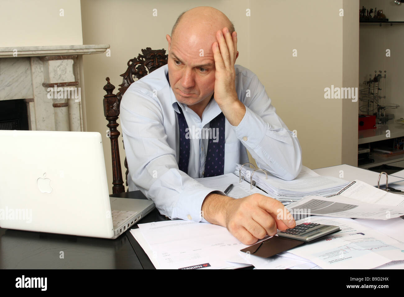 man working on his accounts and worrying about figures Stock Photo - Alamy