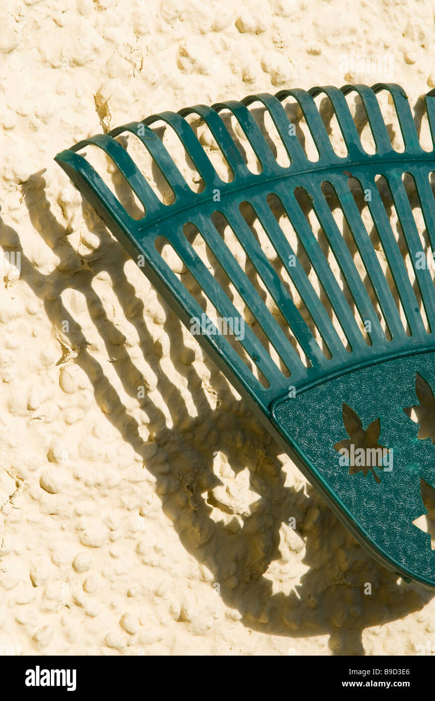 Green plastic rake head and shadow Stock Photo - Alamy