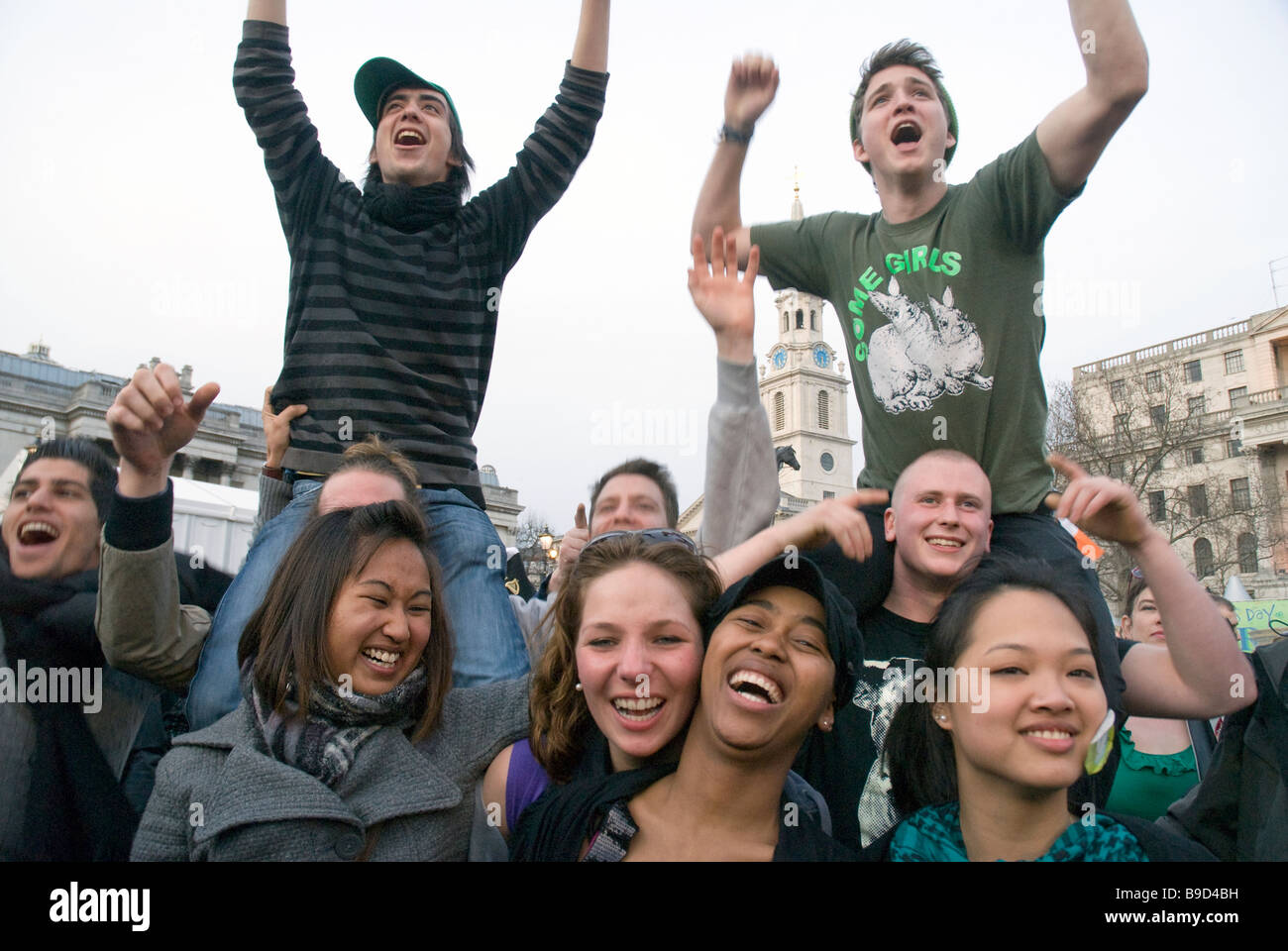 Group of multicultural young men and women celebrating together at St ...