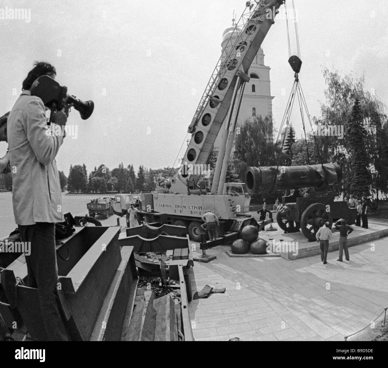 A cameraman shooting the restoration process of the Tsar Cannon in the ...