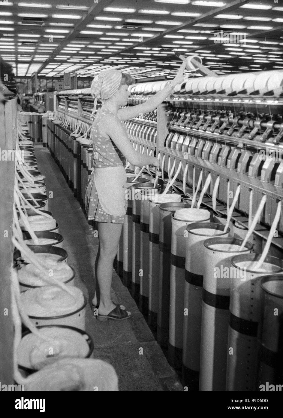 Spinning shop worker checking looms Frunze cotton mill Moscow Stock ...