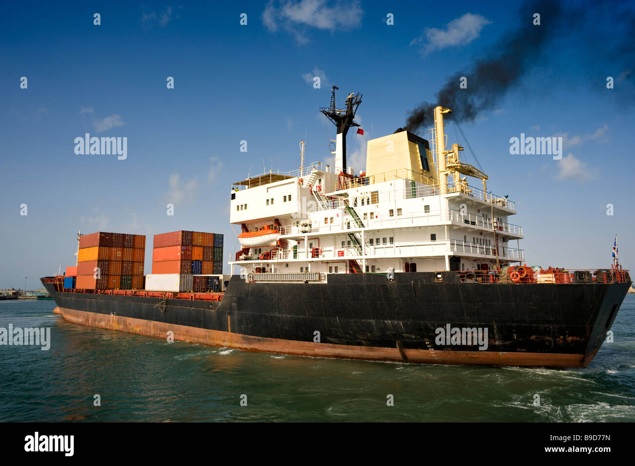cargo ship leaving the port Stock Photo - Alamy