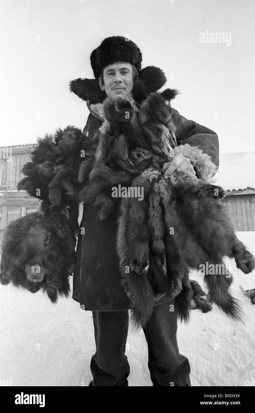 A Siberian fur trapper with his catch Stock Photo - Alamy