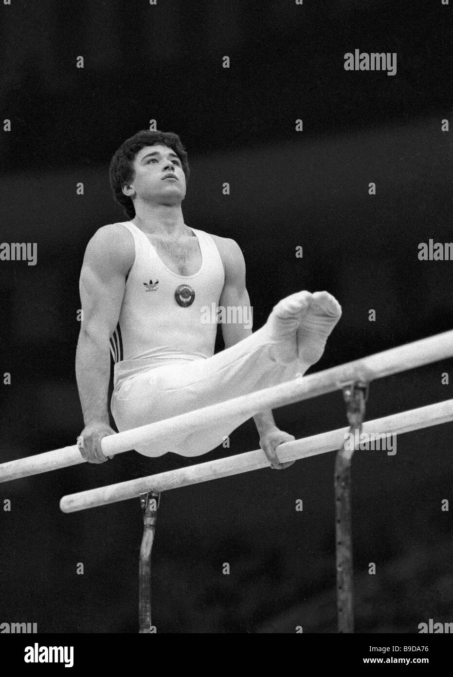 Gymnast Sergei Gusev performing on the bars at 12th international ...