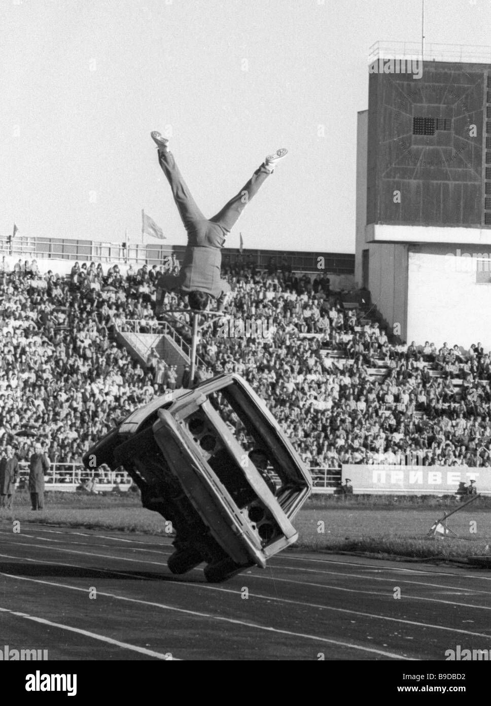 A stuntman in a two wheel driving car trick Stock Photo - Alamy