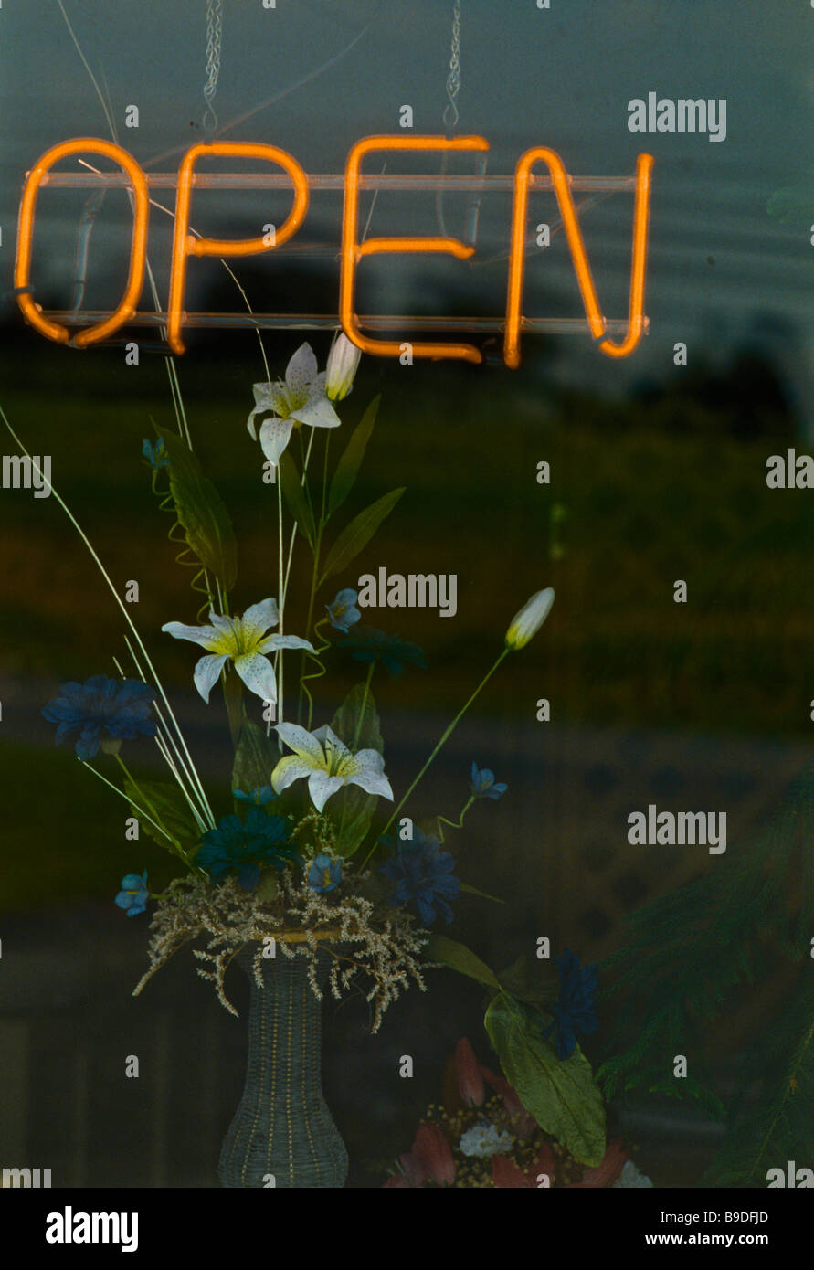 Restaurant open neon sign flowers in window Stock Photo - Alamy