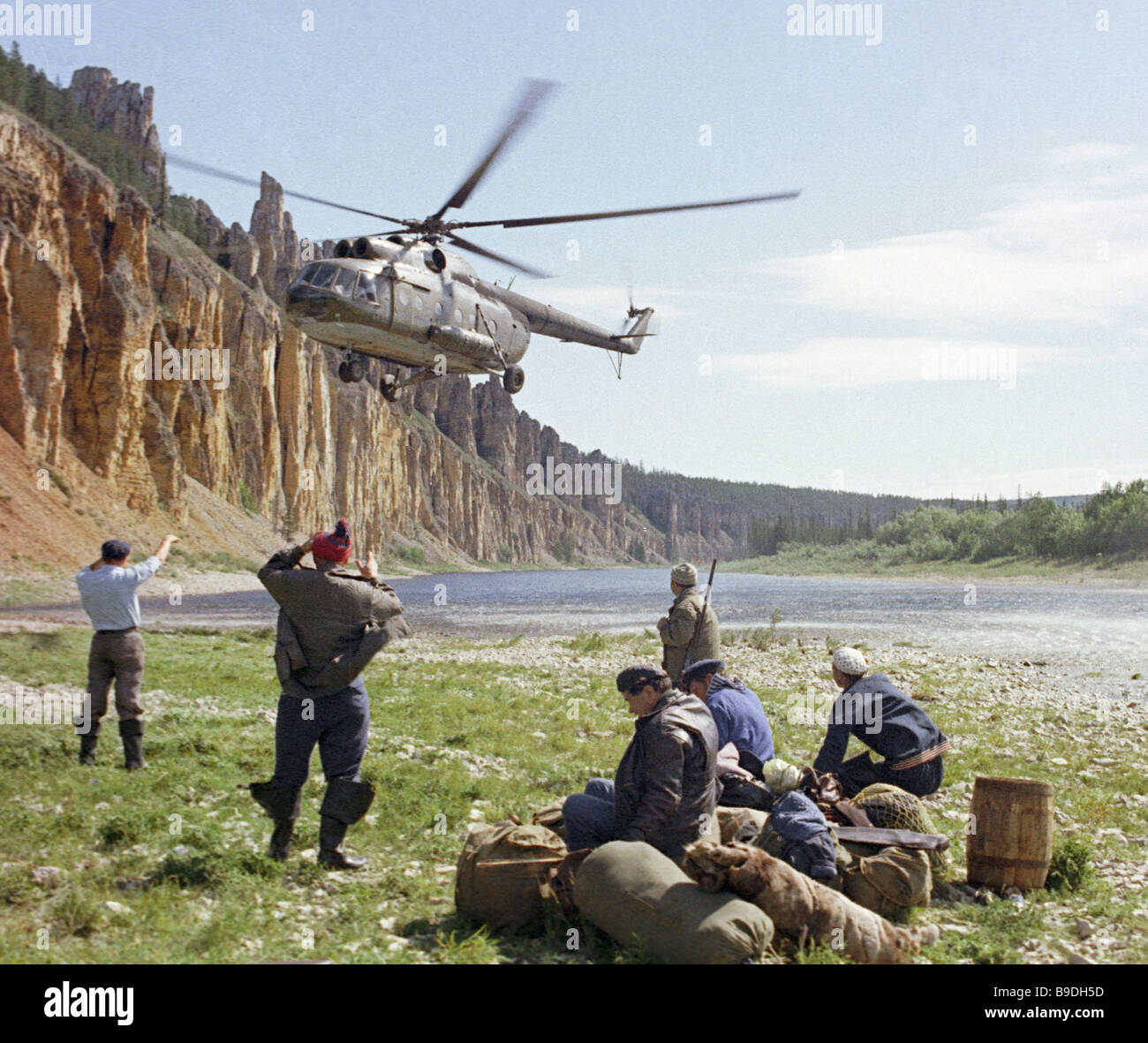 A geologic expedition on the Aldan river bank meets the helicopter ...