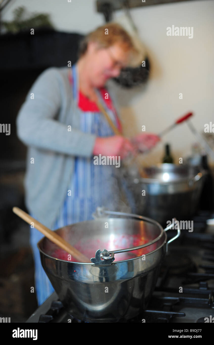 A woman making jam in a kitchen in Dorset Stock Photo - Alamy