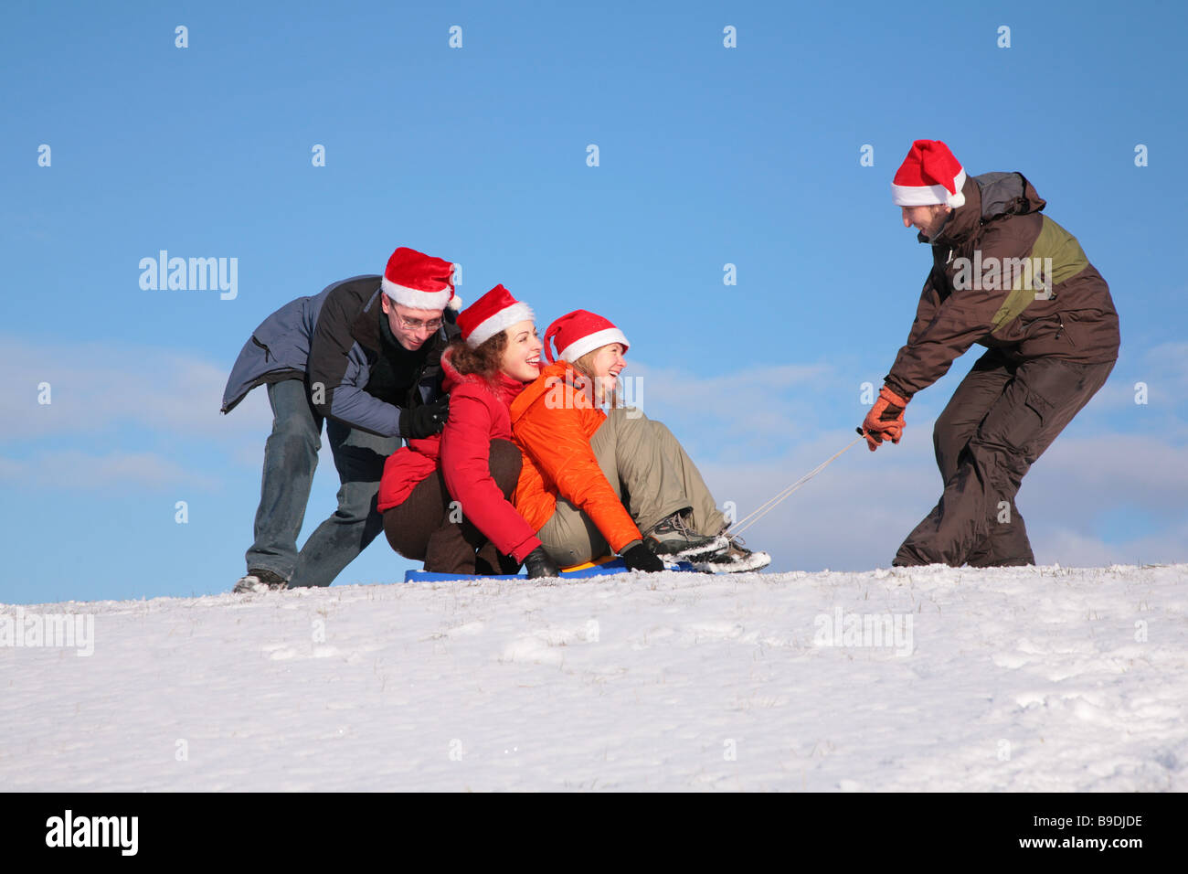 One man pull two girls on sled hi-res stock photography and images - Alamy