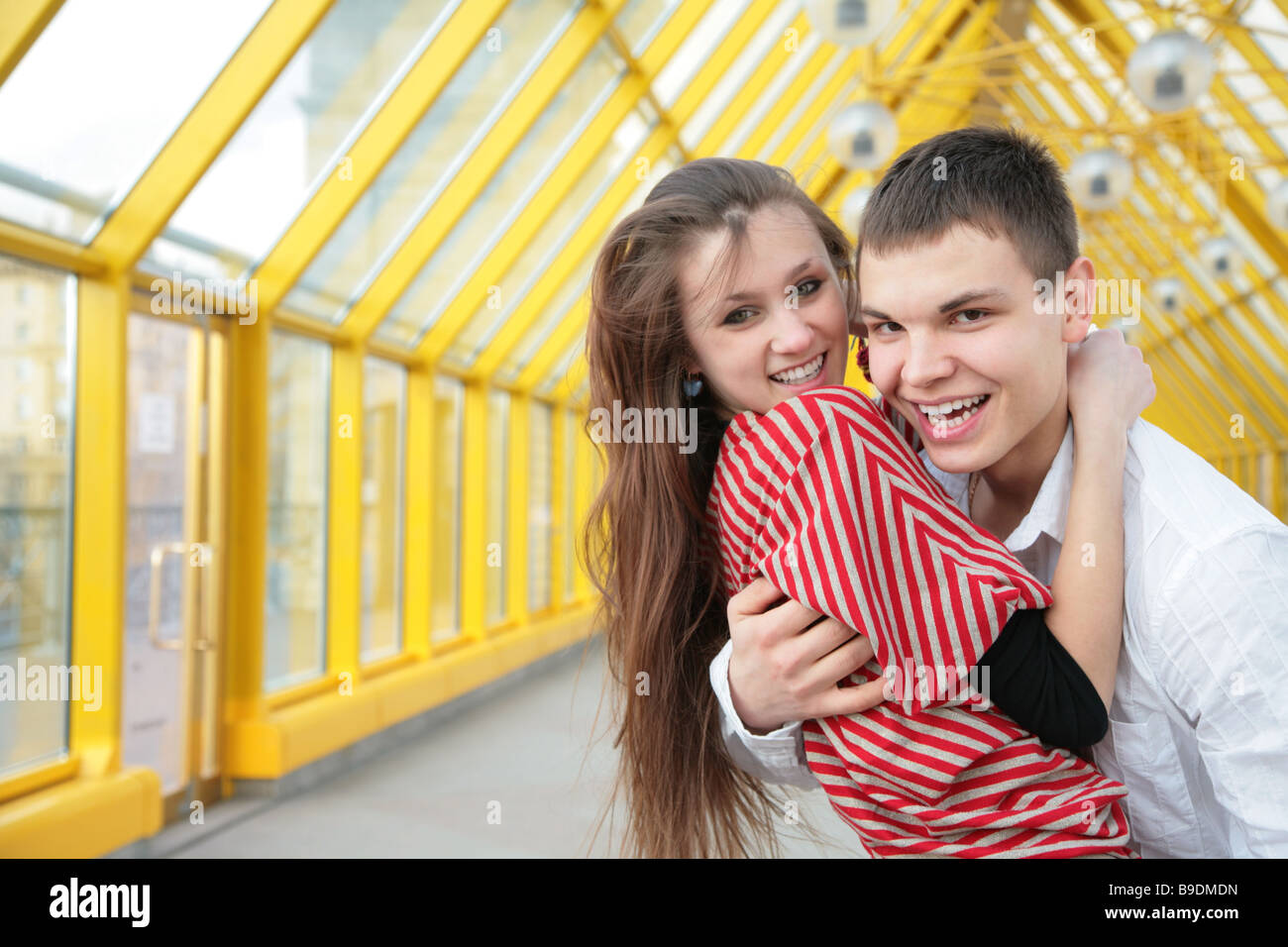 boy embraces girl on footbridge Stock Photo - Alamy