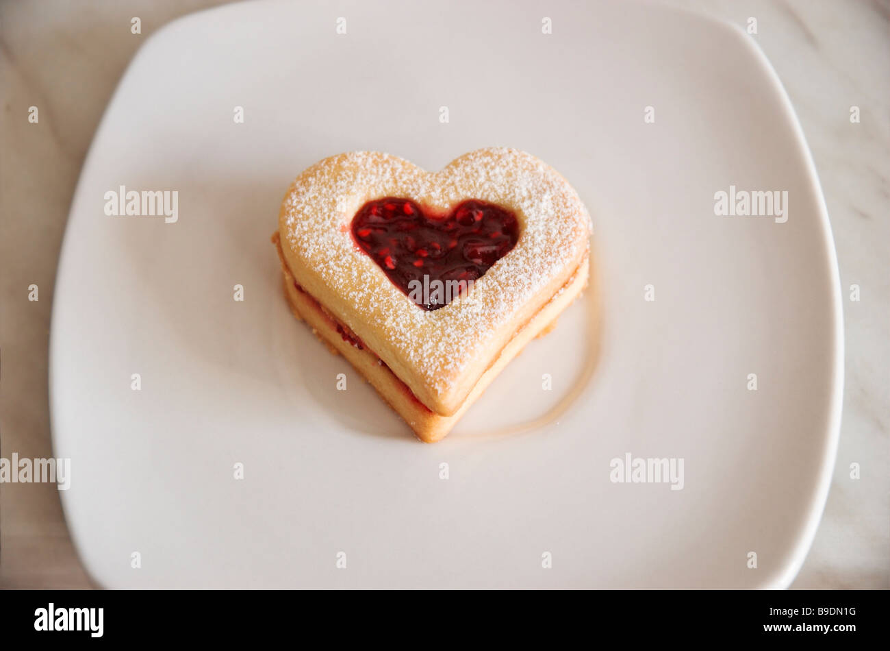 Single shortbread heart shaped cookie on plate Stock Photo - Alamy