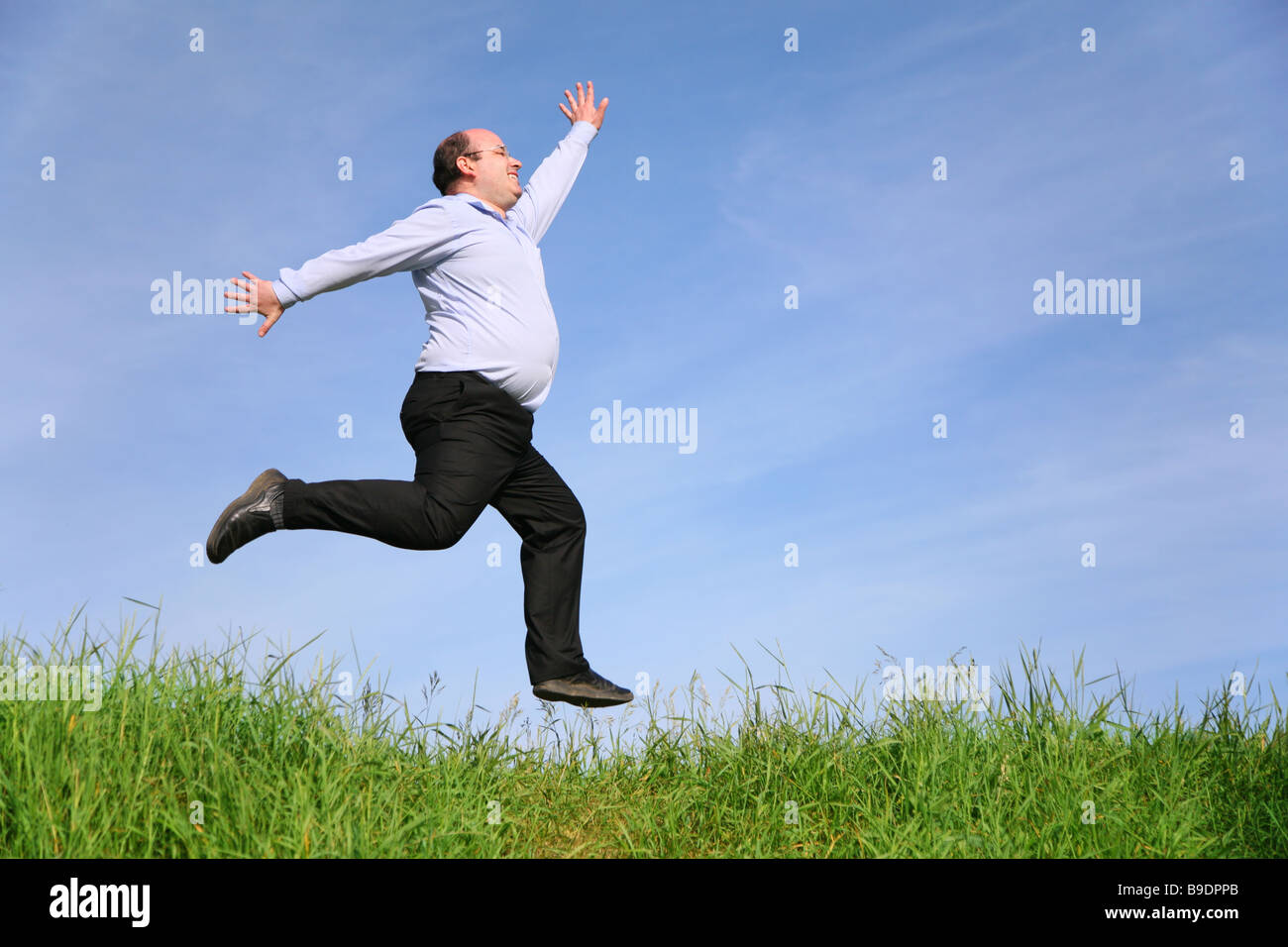 fat man jumps on meadow Stock Photo - Alamy