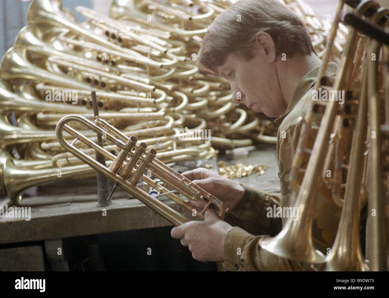 A worker of the Leningrad factory of wind instruments assembling ...