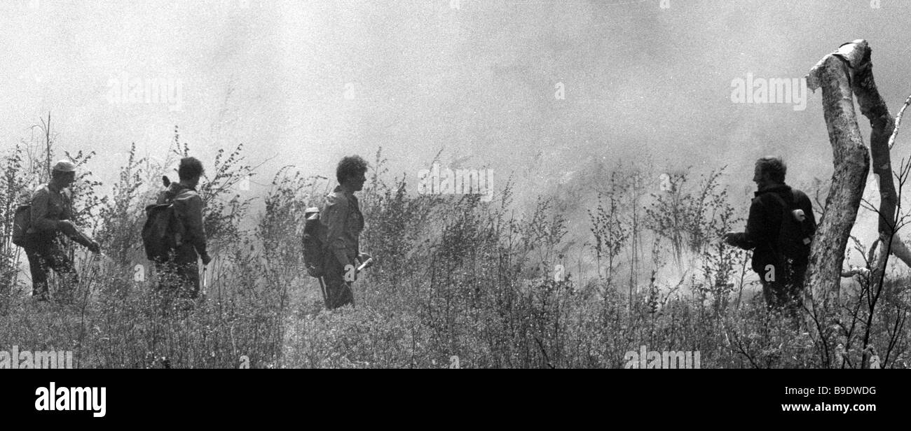 Local people help parachute jumper firemen to put down a forest fire ...
