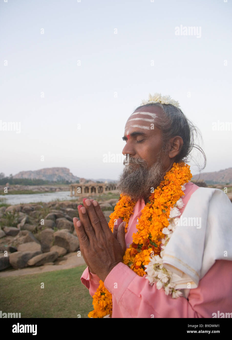 Sadhu standing in a prayer position, Hampi, Karnataka, India Stock ...