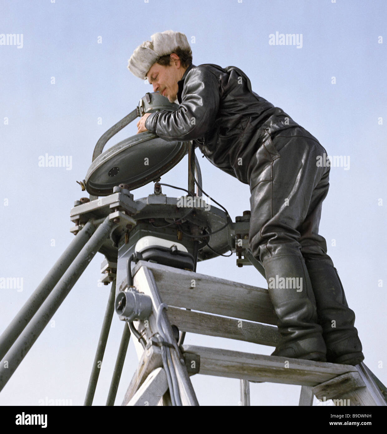 A technician of the Kolba polar station installing research equipment ...